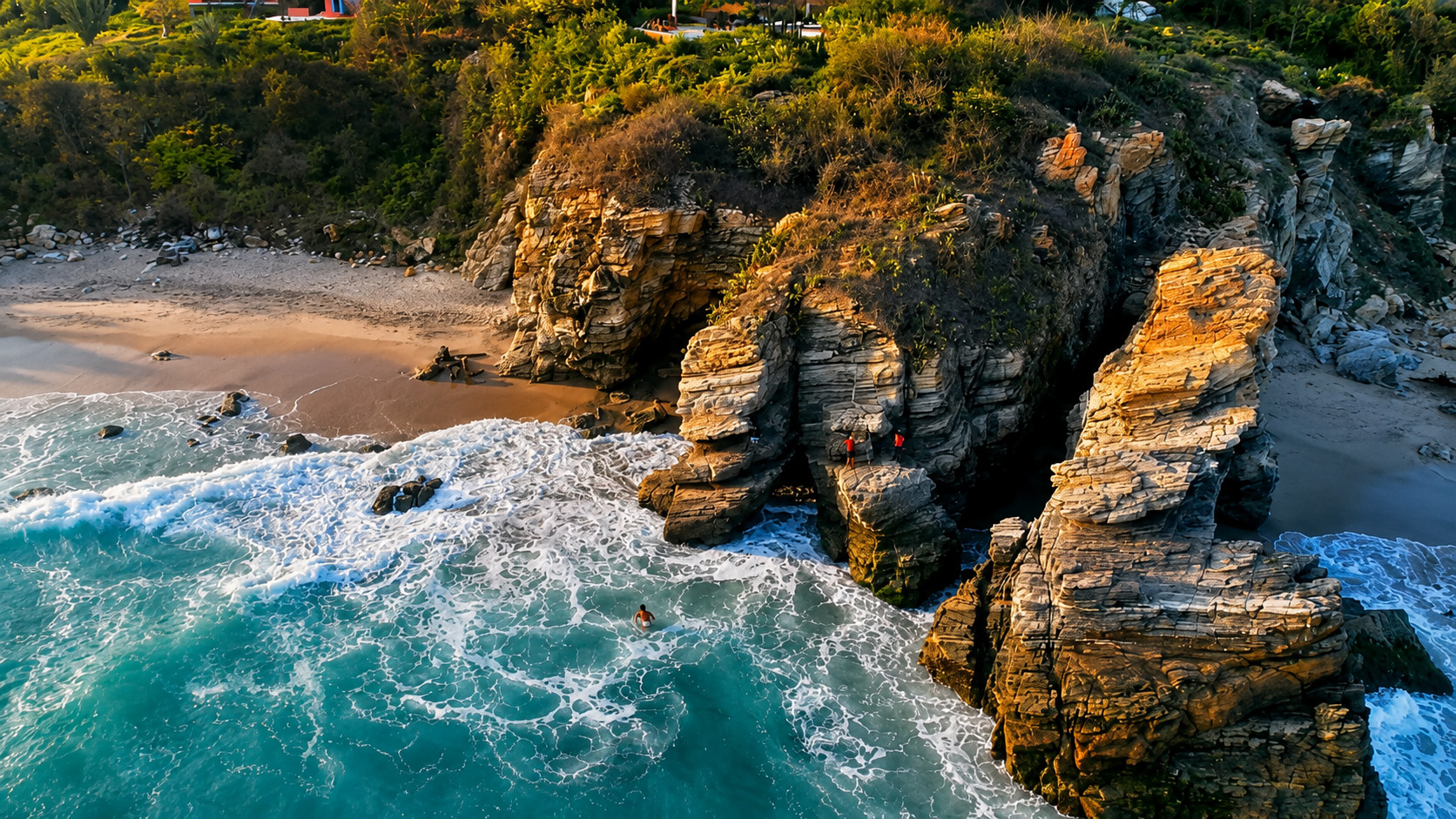 Zicatela Beach where powerful waves meet rocky cliffs