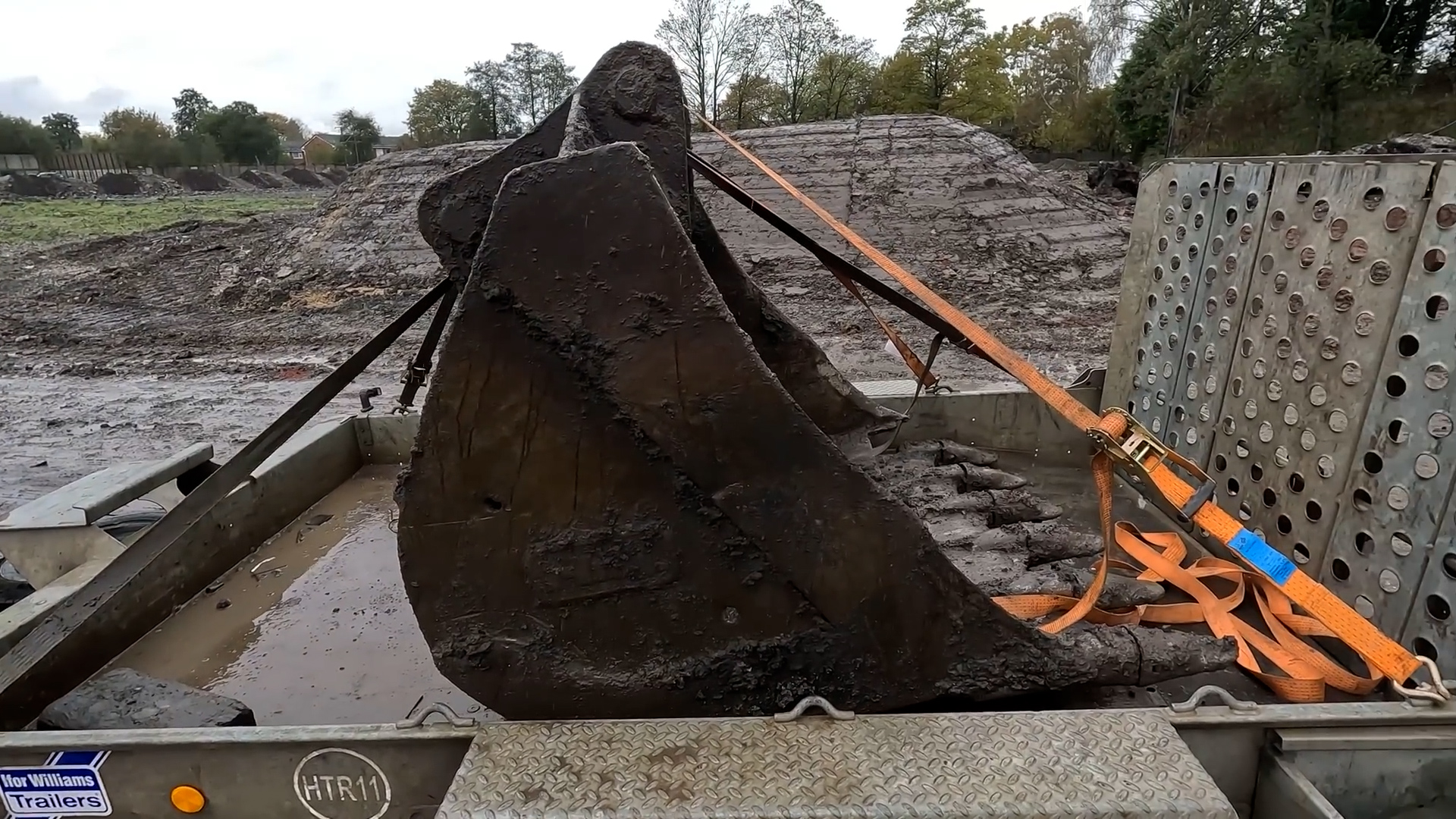 Worn excavator bucket ready for heavy-duty welding repair