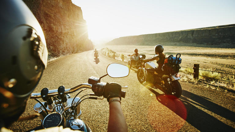 What does it mean when a biker opens and closes their left fist?