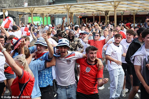 Beers go flying as England fans throw their arms around each other as ...