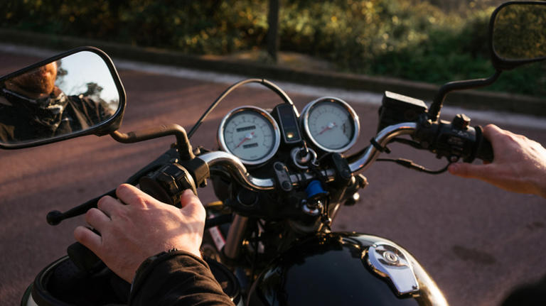 What does it mean when a biker opens and closes their left fist?