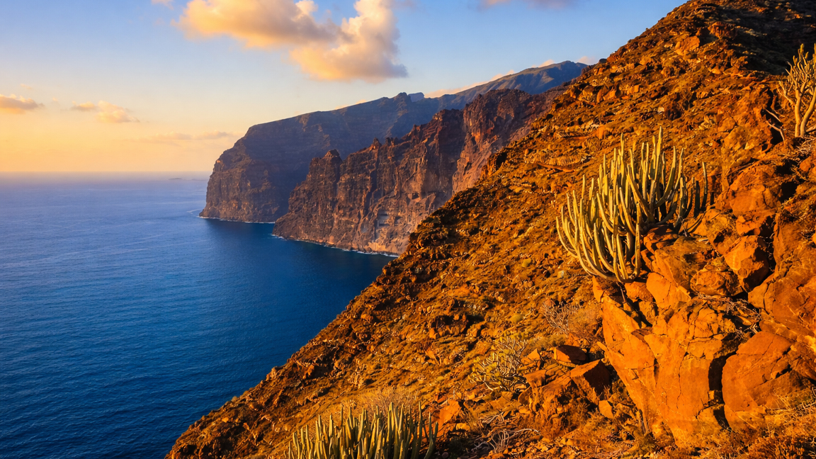 Golden sunlight across a rugged volcanic coastline