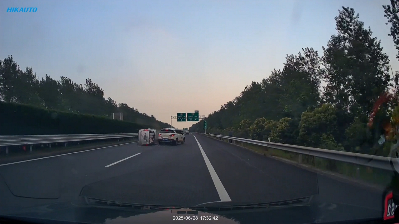 White car crashes into overturned van on Shanghai highway