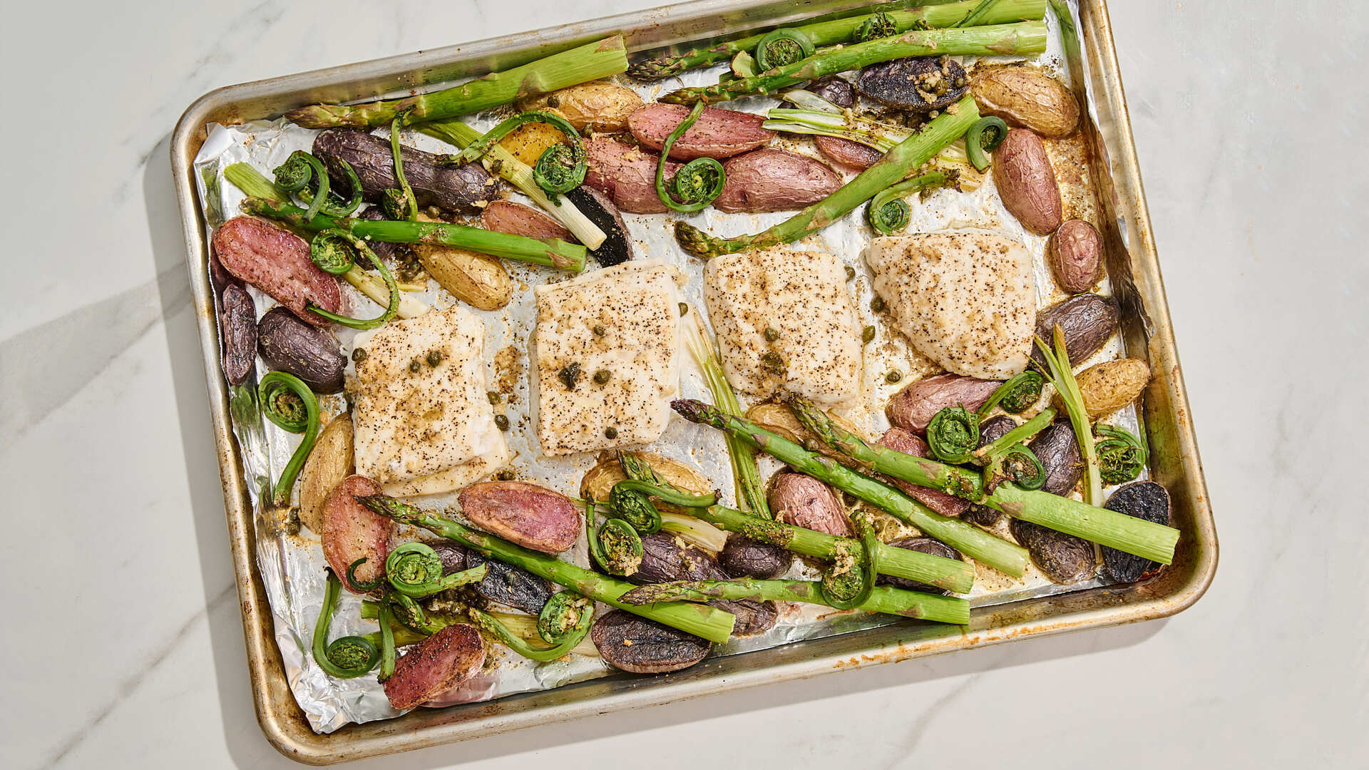 Sheet pan garlic butter halibut with spring vegetables recipe