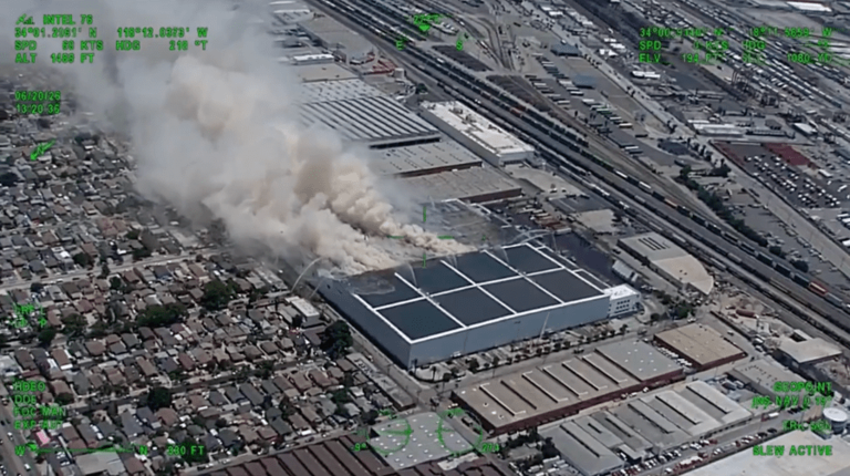 Aerial footage shows expansive warehouse fire burning since Wednesday ...