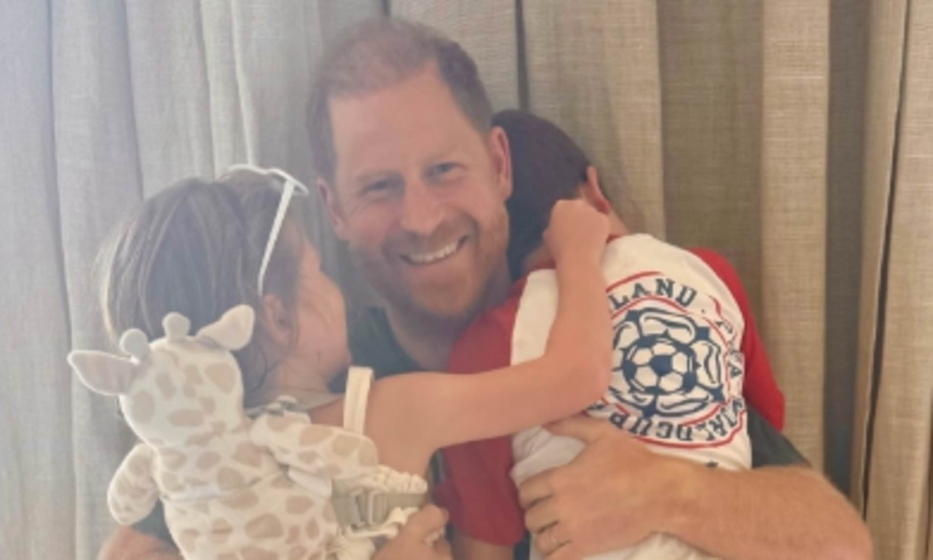 Meghan posts picture of Harry embracing Archie and Lilibet as she marks ...