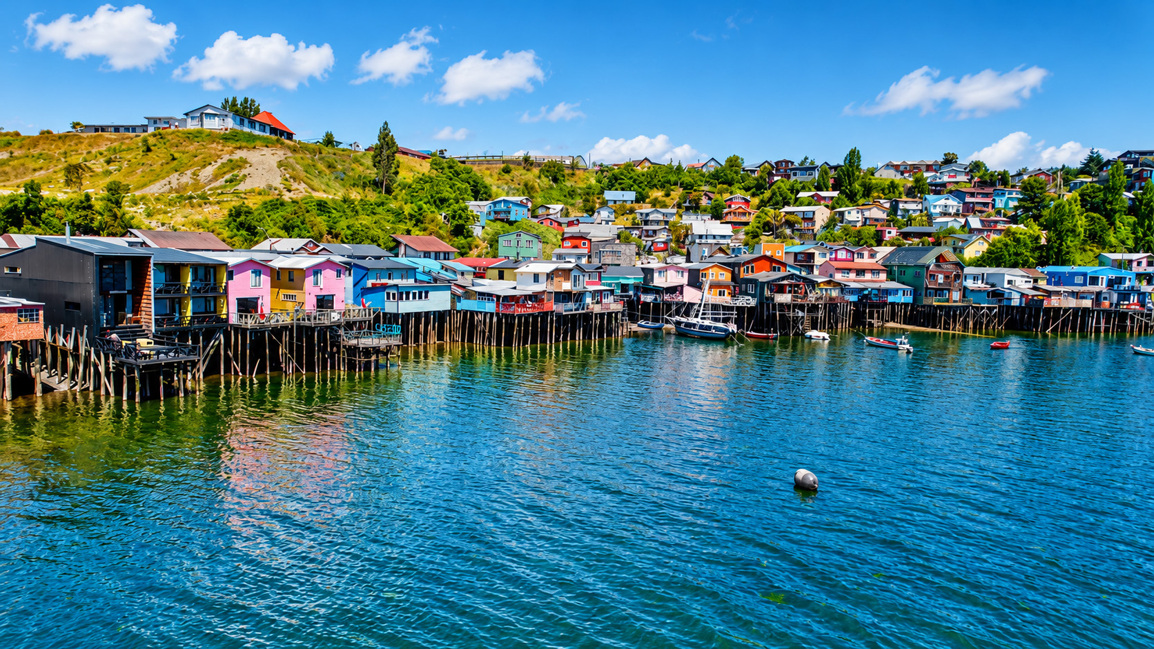A colorful coastal village overlooking the shores of Chiloé Island