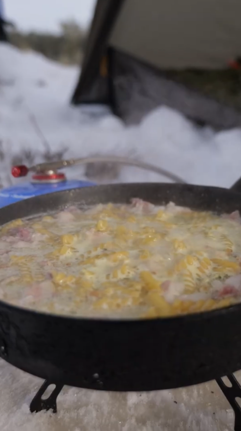 Winter camping in deep snow with shelter and camp cooking