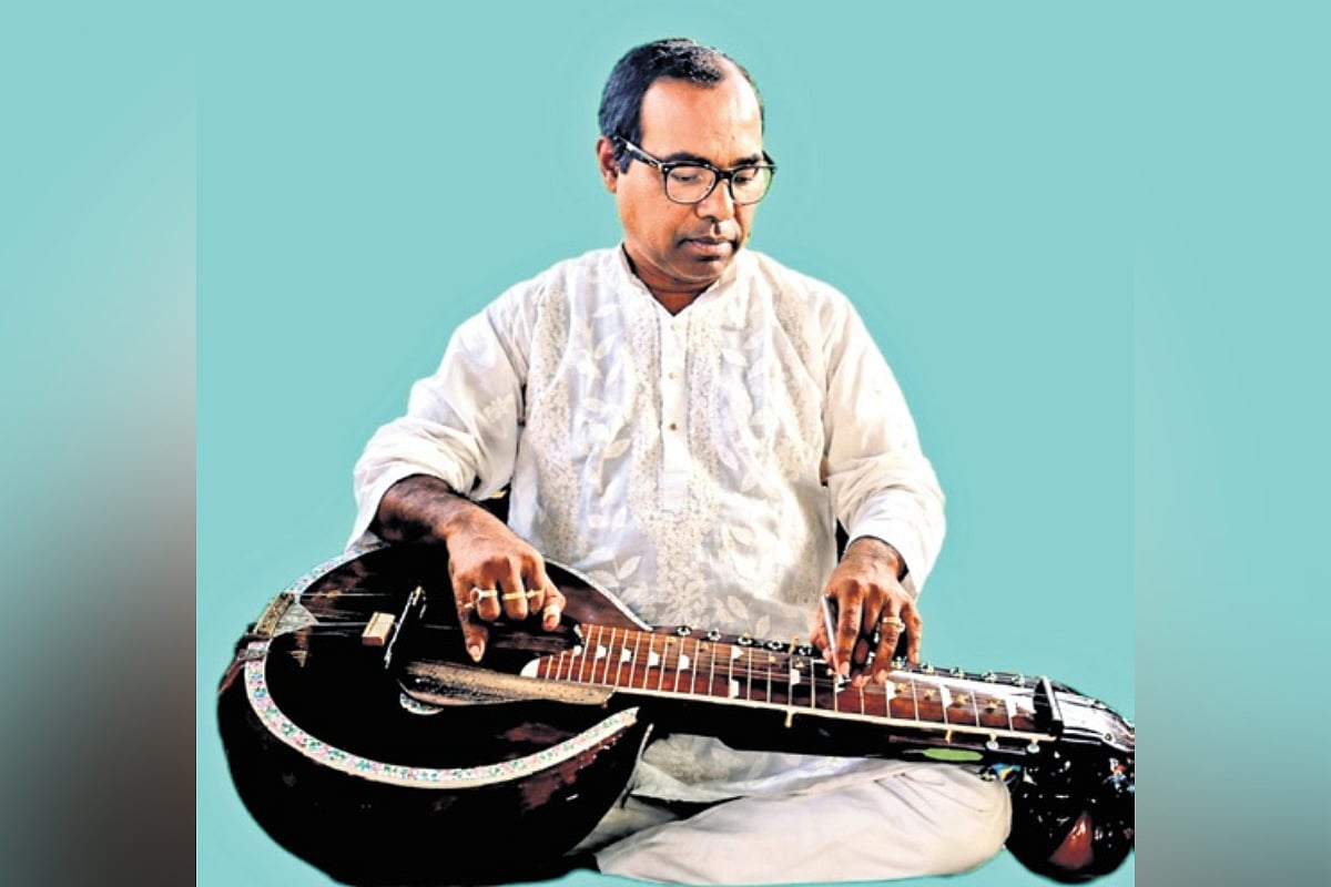 School headmaster from Tripura develops 22-string modified guitar for ...