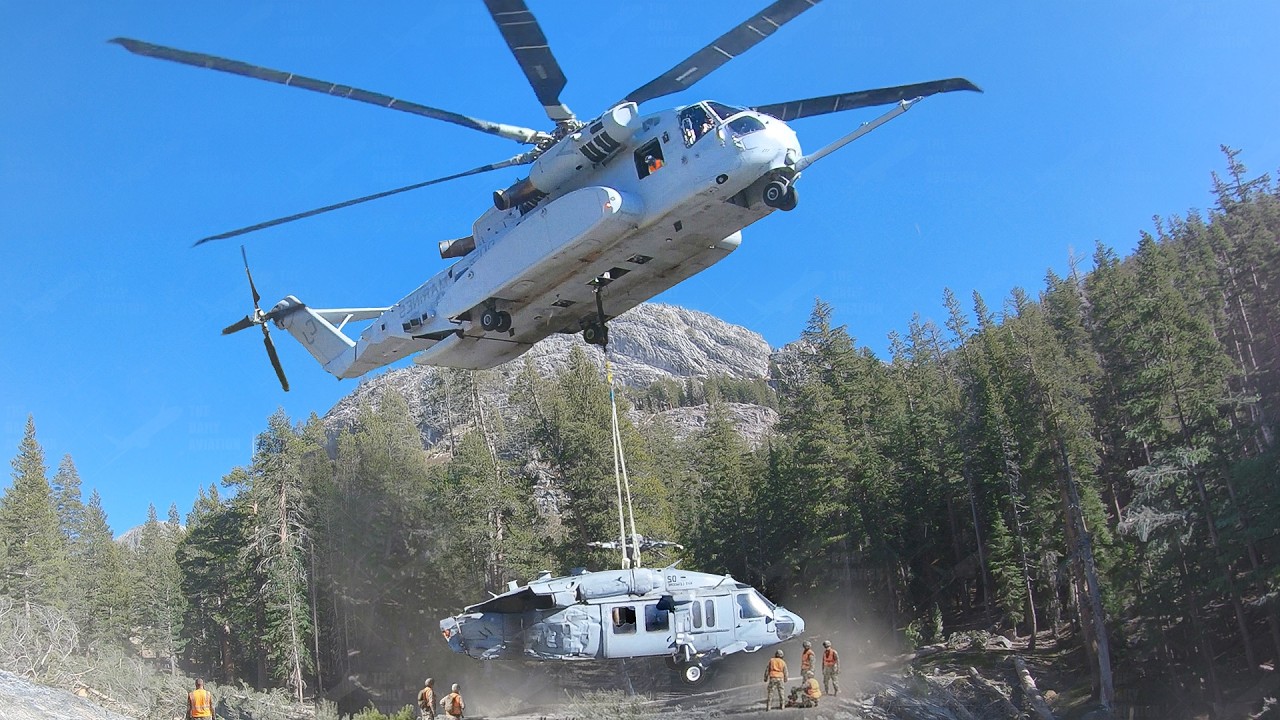 Largest US helicopter lifts a crashed helicopter in the mountains