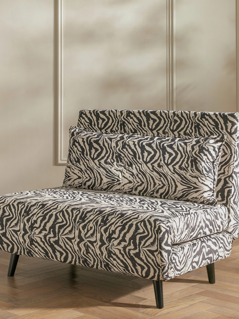 This compact futon-style sofa bed looks better in sleep mode
