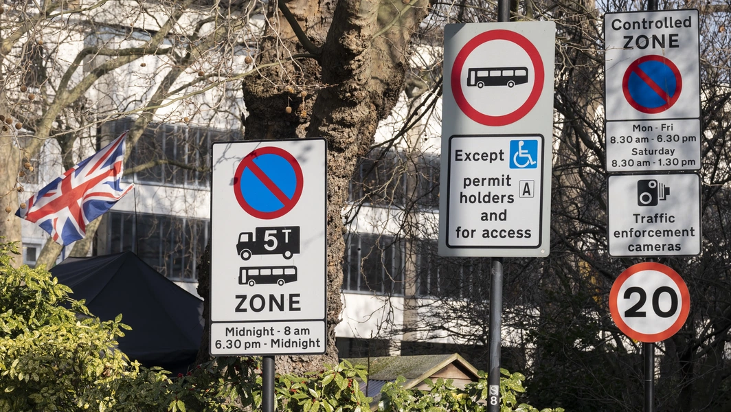 Red-bordered road signs in the UK and Texas