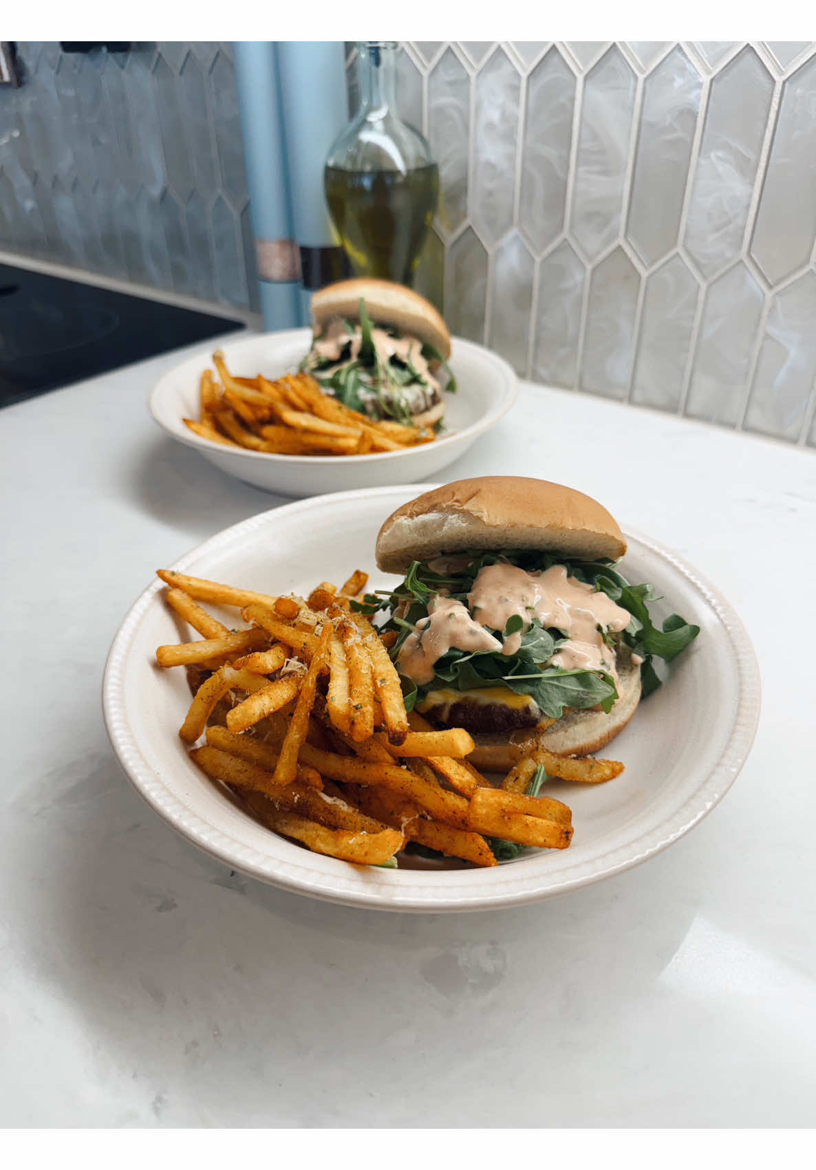 Making a juicy homemade cheeseburger with seasoned fries and a creamy ...