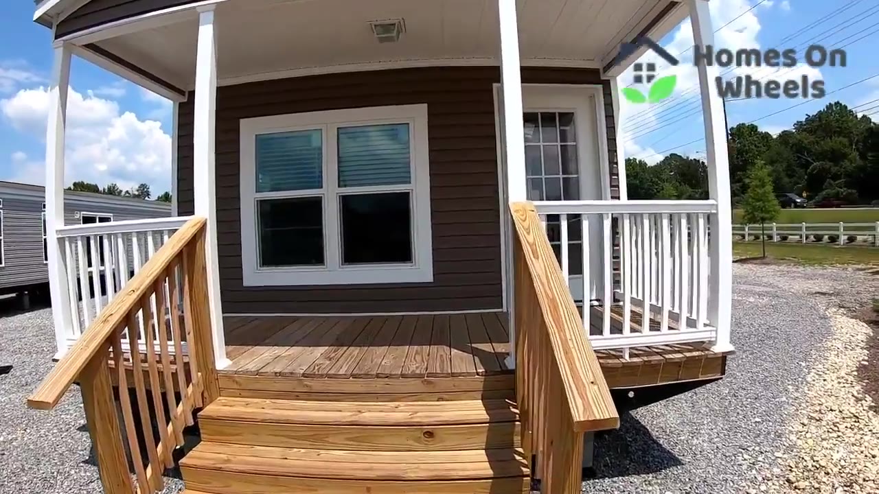 A tiny home with full-size laundry, two baths, and a metal roof feels ...