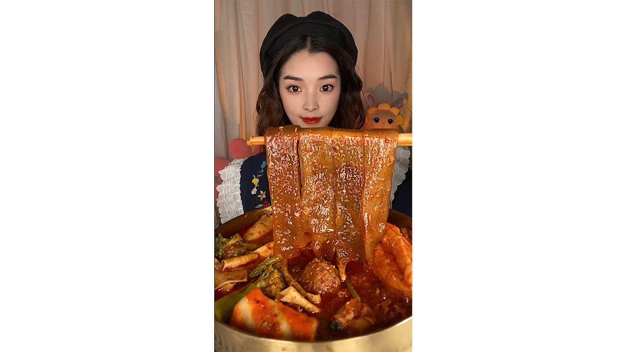 Eating giant glass noodles mukbang with spicy Korean hot pot feast