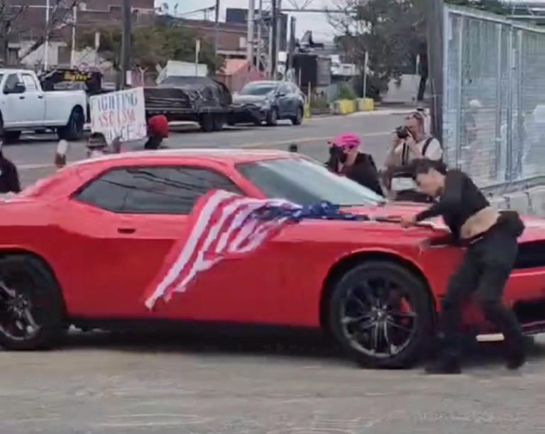 Anti-ICE protester hit by car while waving upside-down US flag outside ...