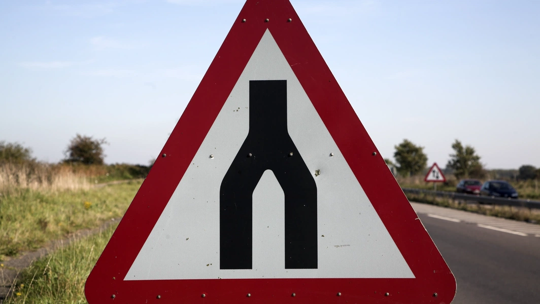 Red-bordered road signs in the UK and Texas