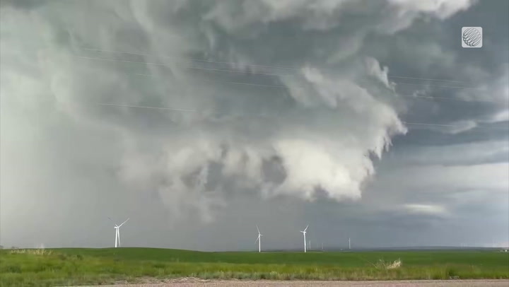 Supercell spins over open, rural field in Alberta
