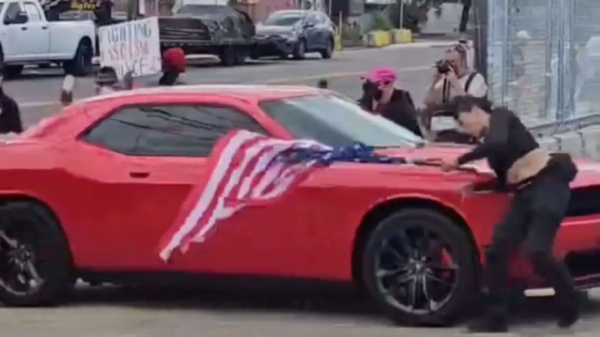Anti-ICE protester waving upside-down US flag hit by car in New Jersey ...