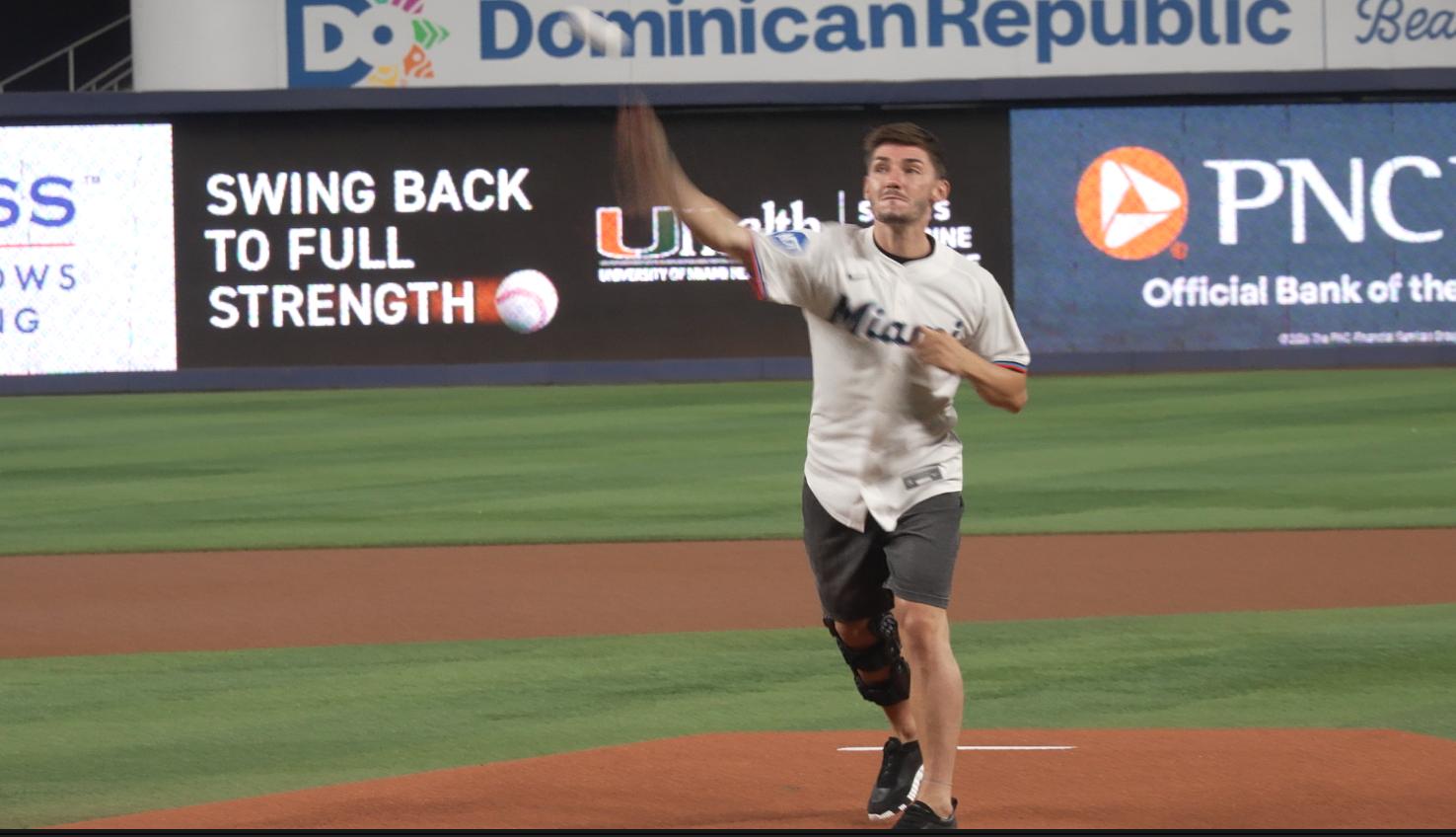 MOMENT: Injuried Gilmour throws first pitch as Scottish bagpipe band ...