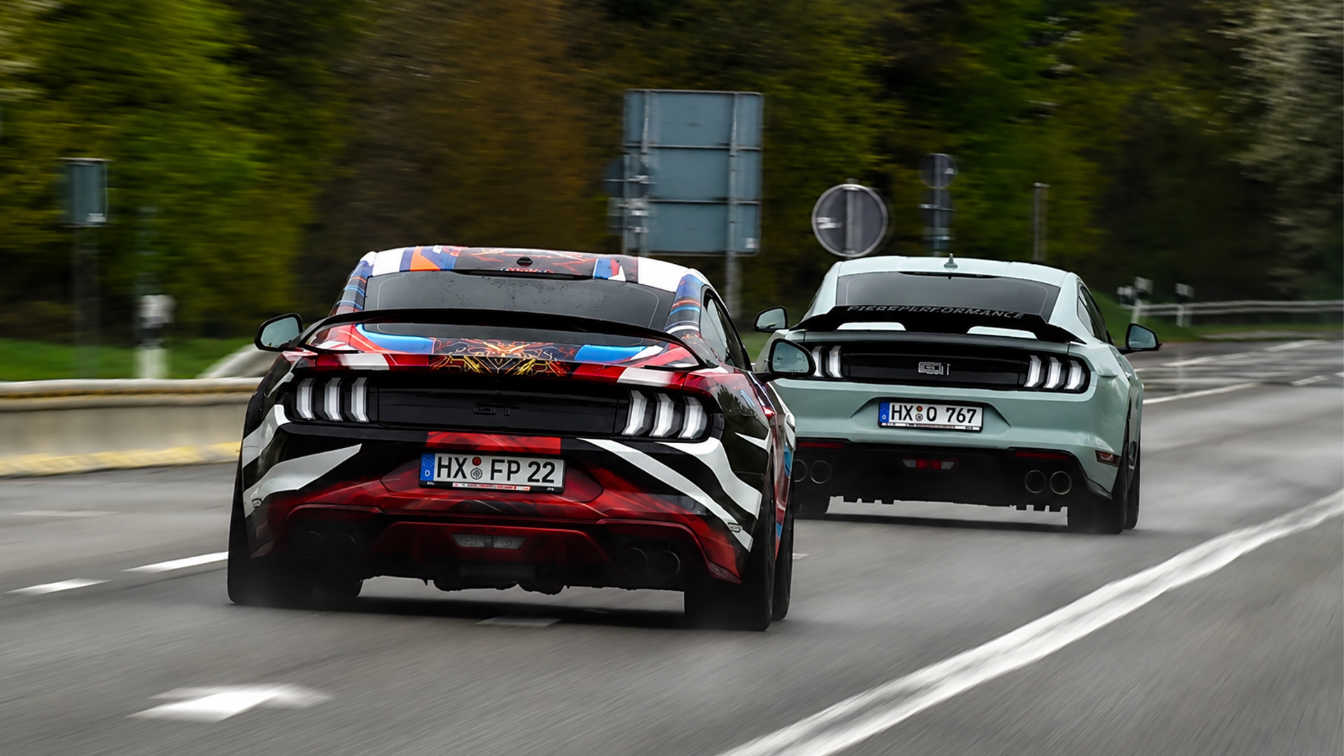 Two Ford Mustang GTs battle on public road