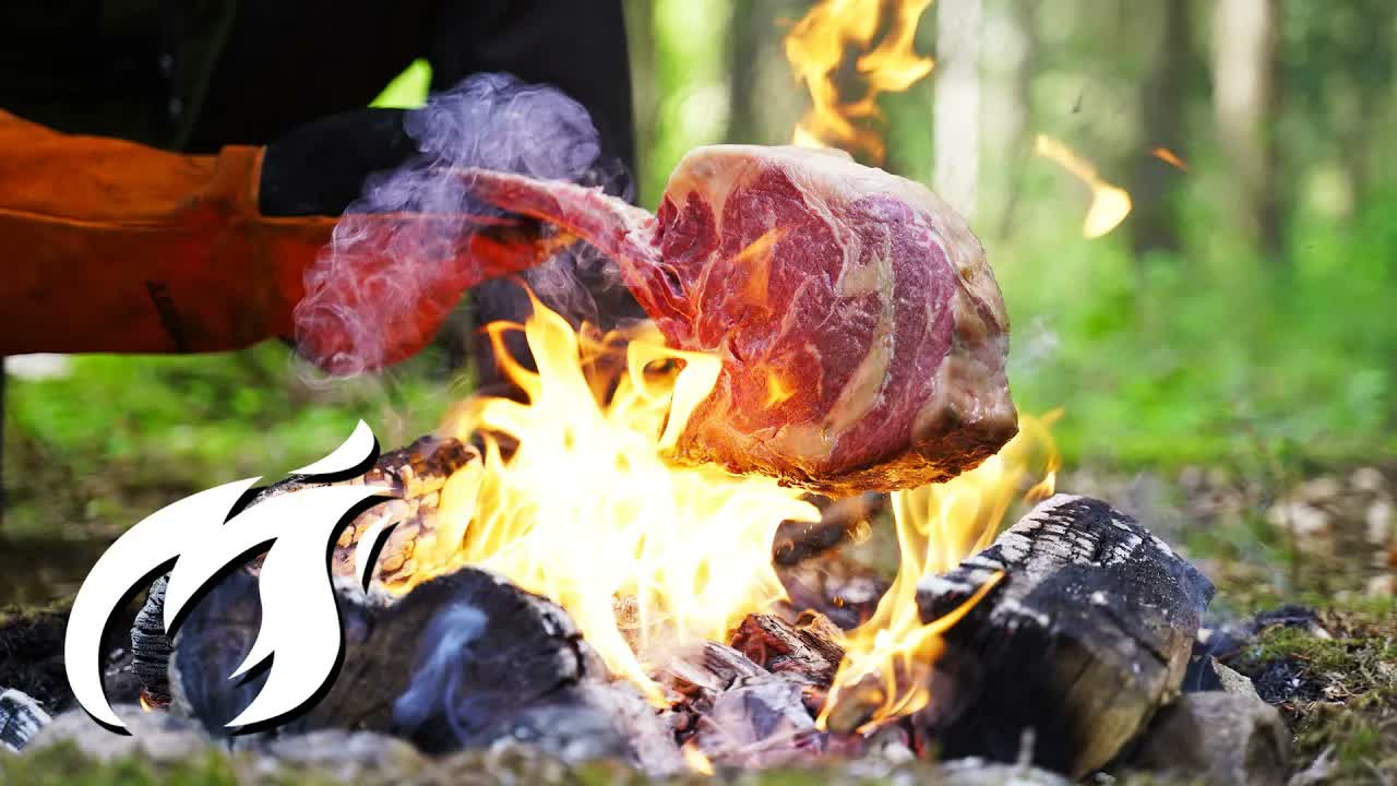Extreme outdoor cooking: Why his hands are into the fire?