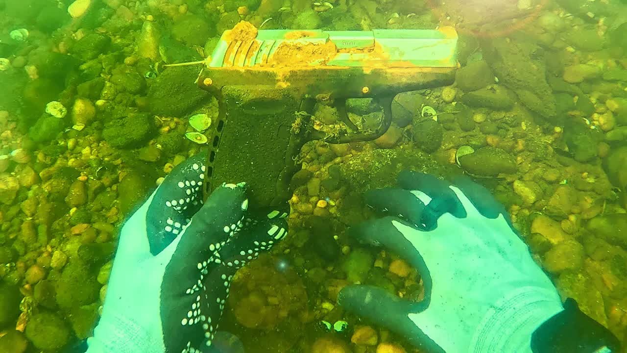 A river diver pulled up a 9mm pistol - "Potential murder weapon" - then ...