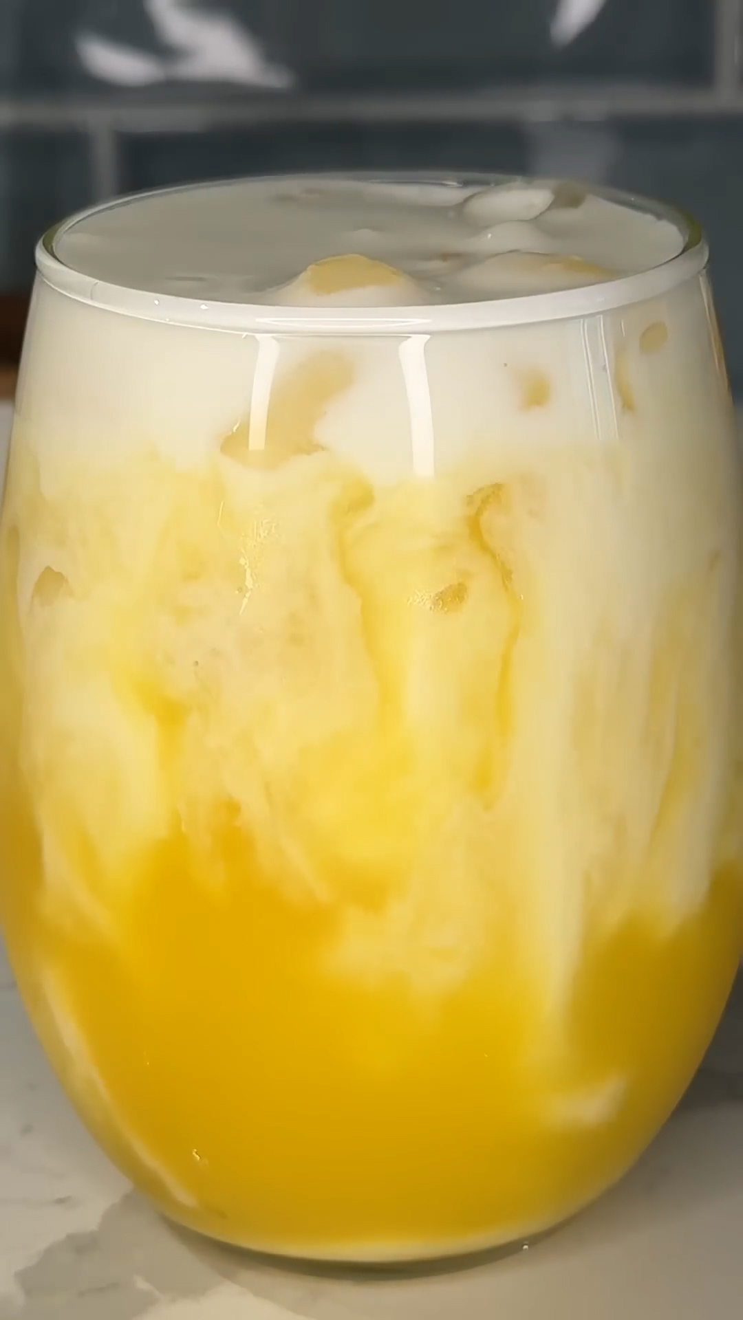 Bright orange lemonade shaken over ice for a refreshing summer drink