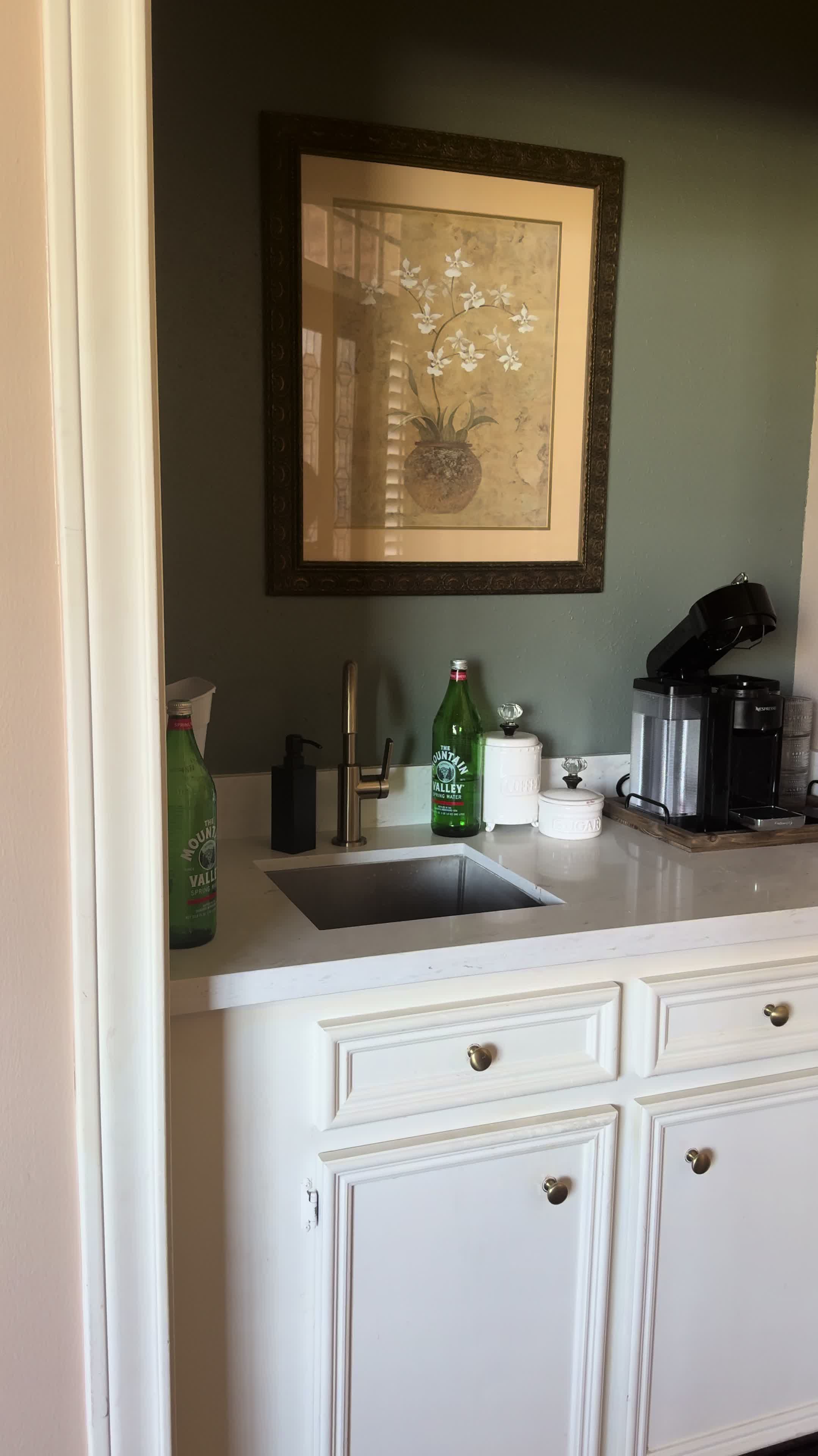 Showing off the party ready wet bar and coffee station with Nespresso ...