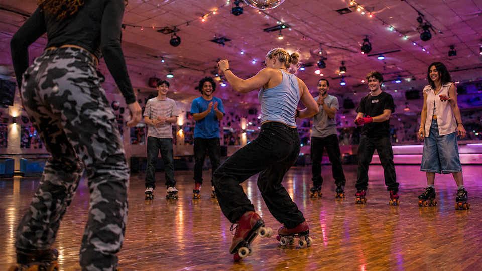 Roller skaters glide through smooth disco moves