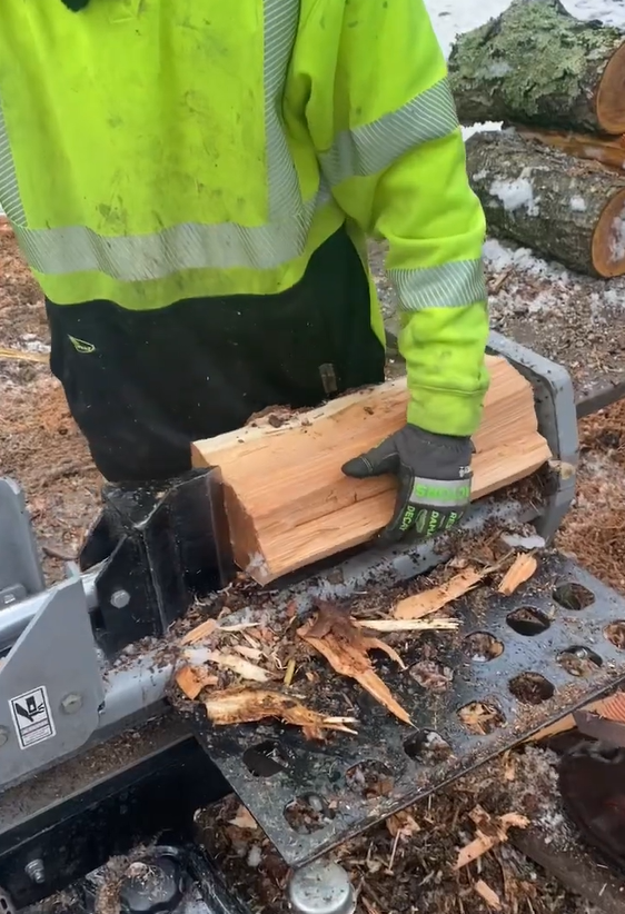 Firewood conveyor in action: outdoor logging and wood processing