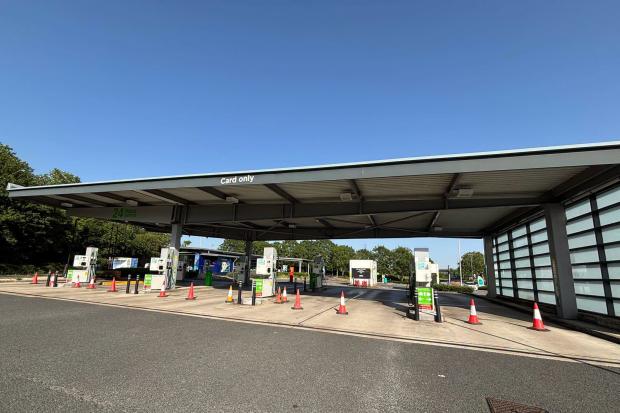 Busy town filling station closed and coned off to drivers