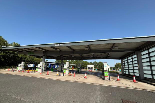 Busy town filling station closed and coned off to drivers