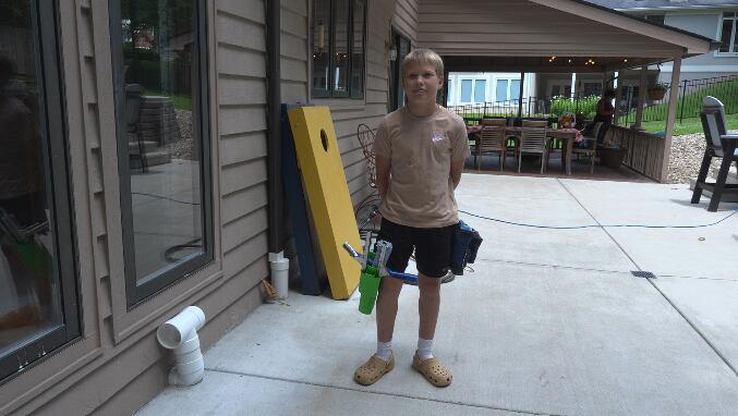 Young entrepreneur stays busy cleaning windows instead of staying inside