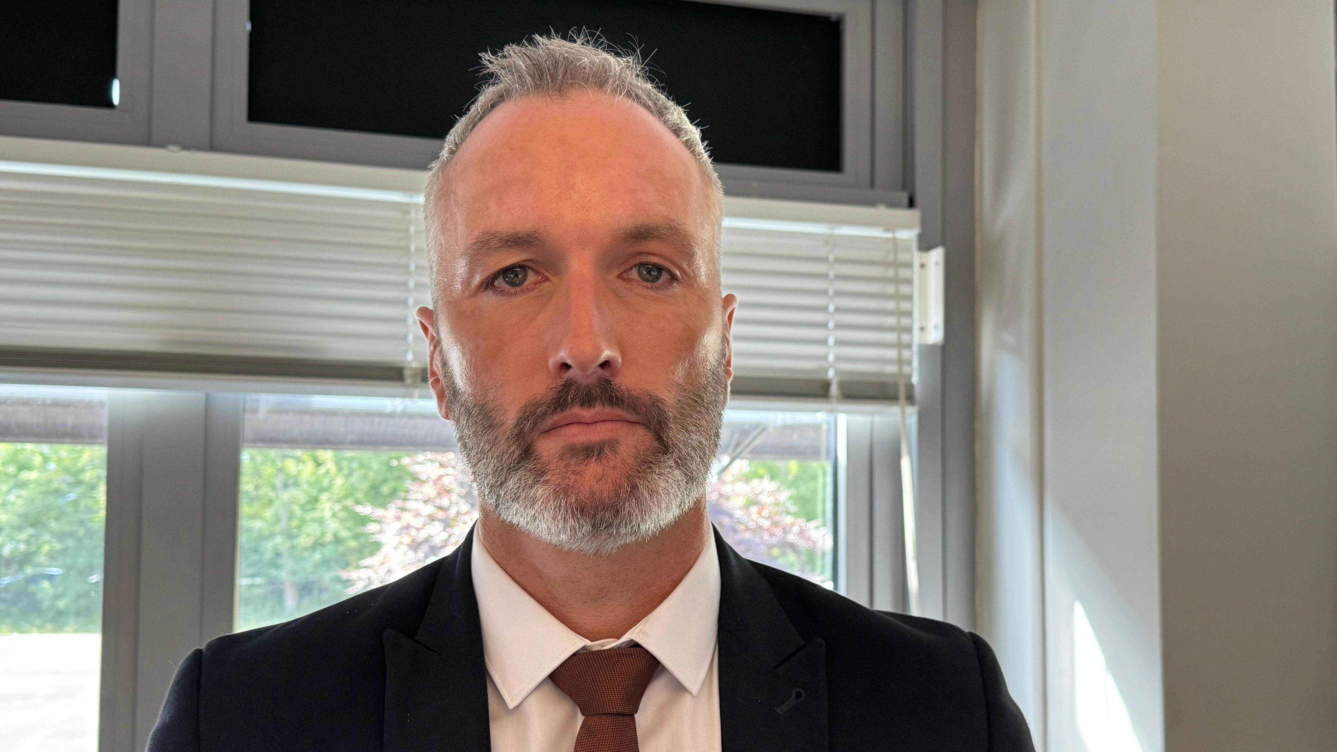 Detective charged with operating equipment beneath clothing