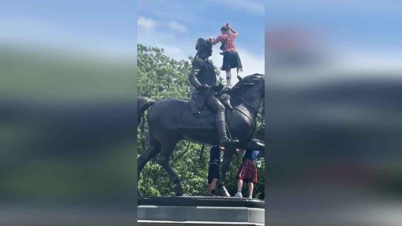 Scottish fans climb George Washington statue and place traffic cone ...