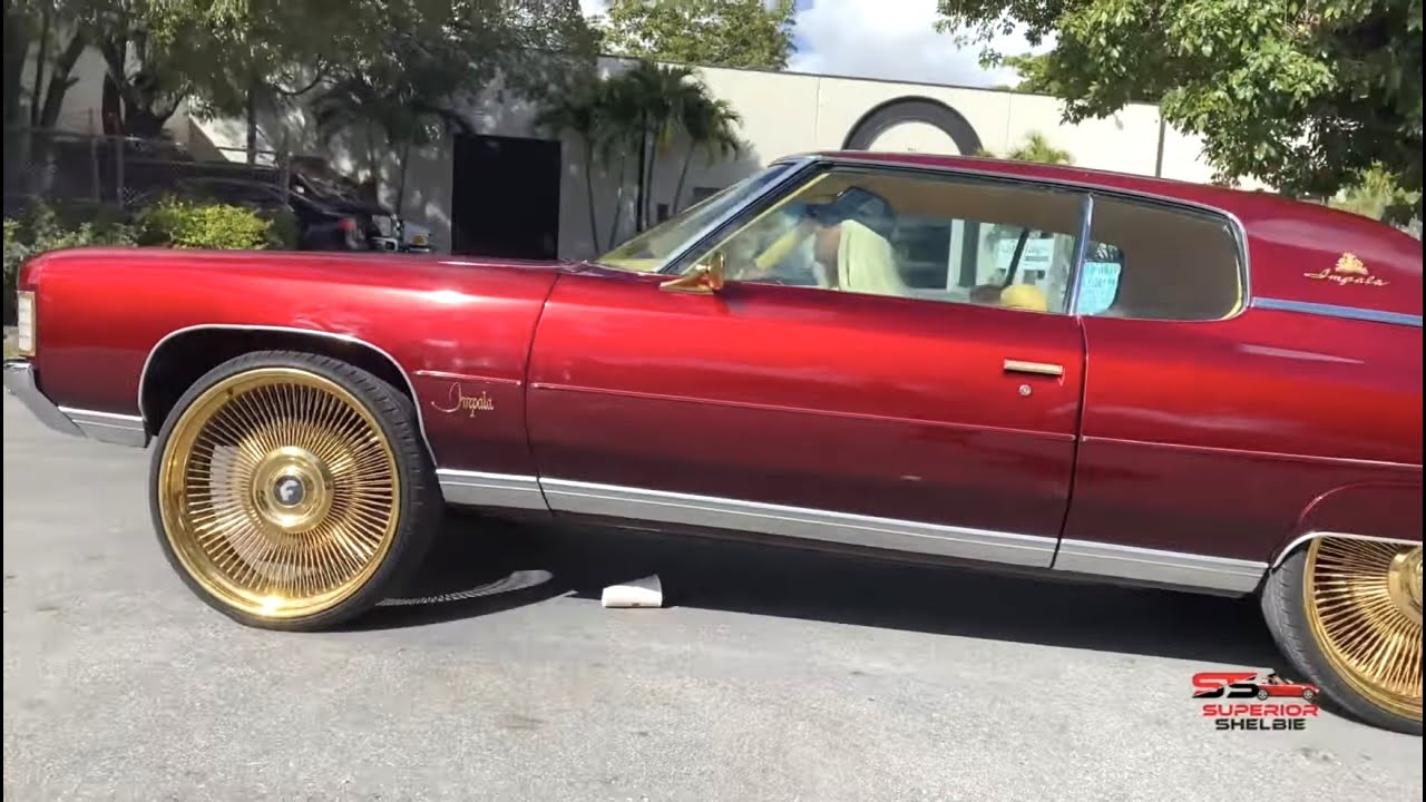 Candy red 71 Chevy Impala on 26” gold Forgiato spokes | Superior Shelbie