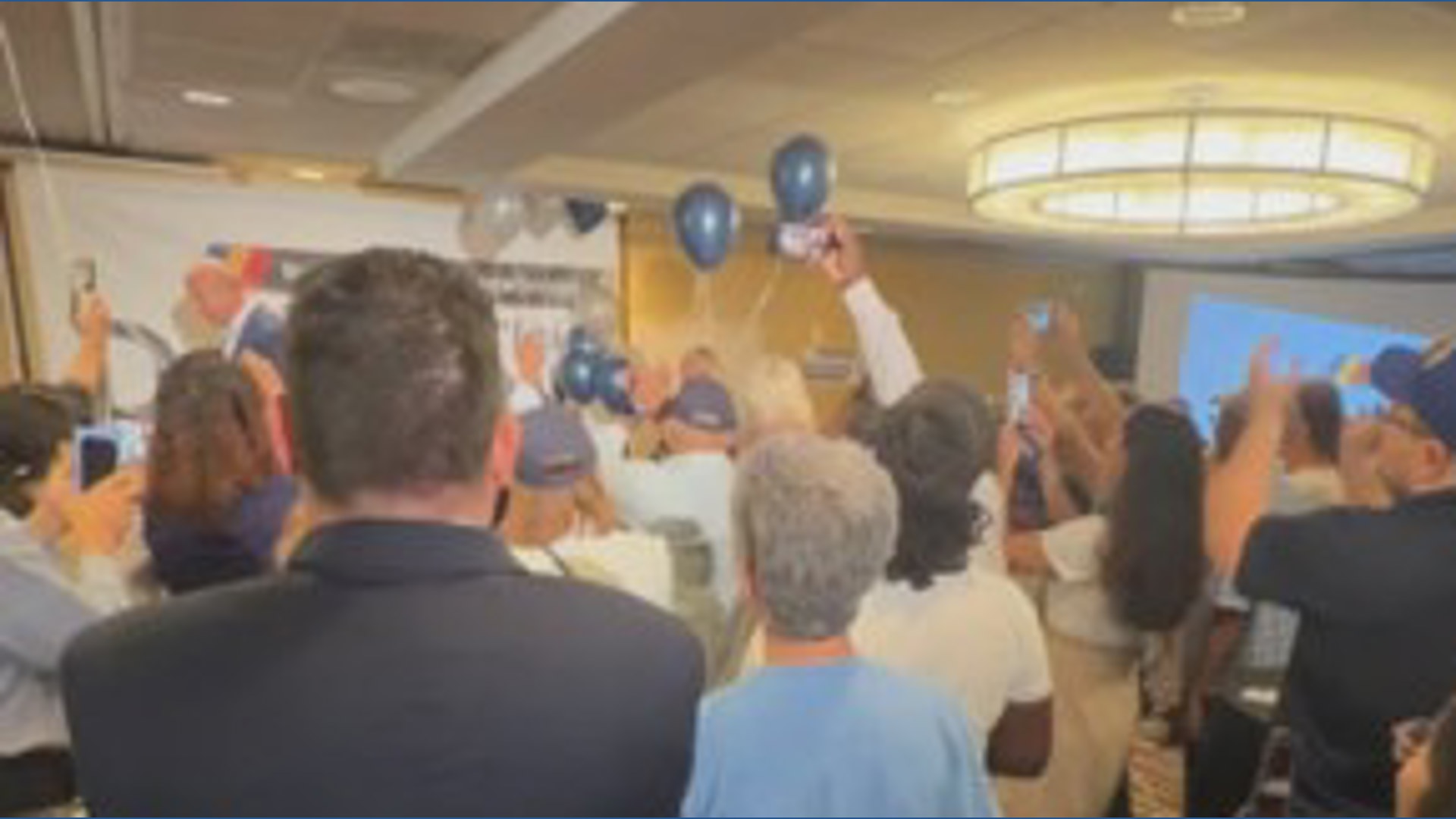April McClain Delaney speaks to supporters as votes are counted