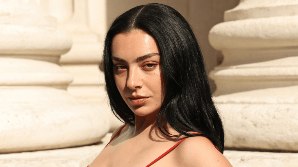 Charli XCX tops off $10K see-through dress look with YSL pouch & pumps