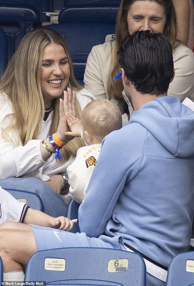 Declan Rice beams as he and partner Lauren Fryer hold baby in stands ...
