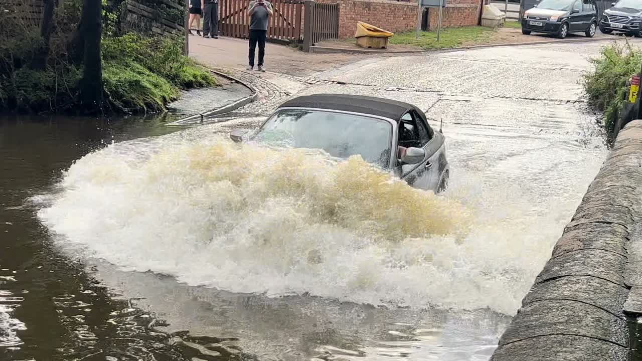 He hit the flood at full speed - seconds later his car vanished behind ...