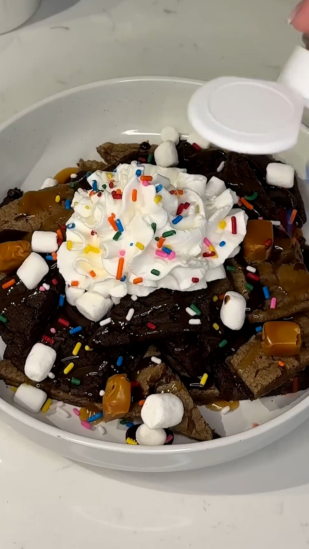Cookie pieces layered with chocolate and toppings like loaded nachos