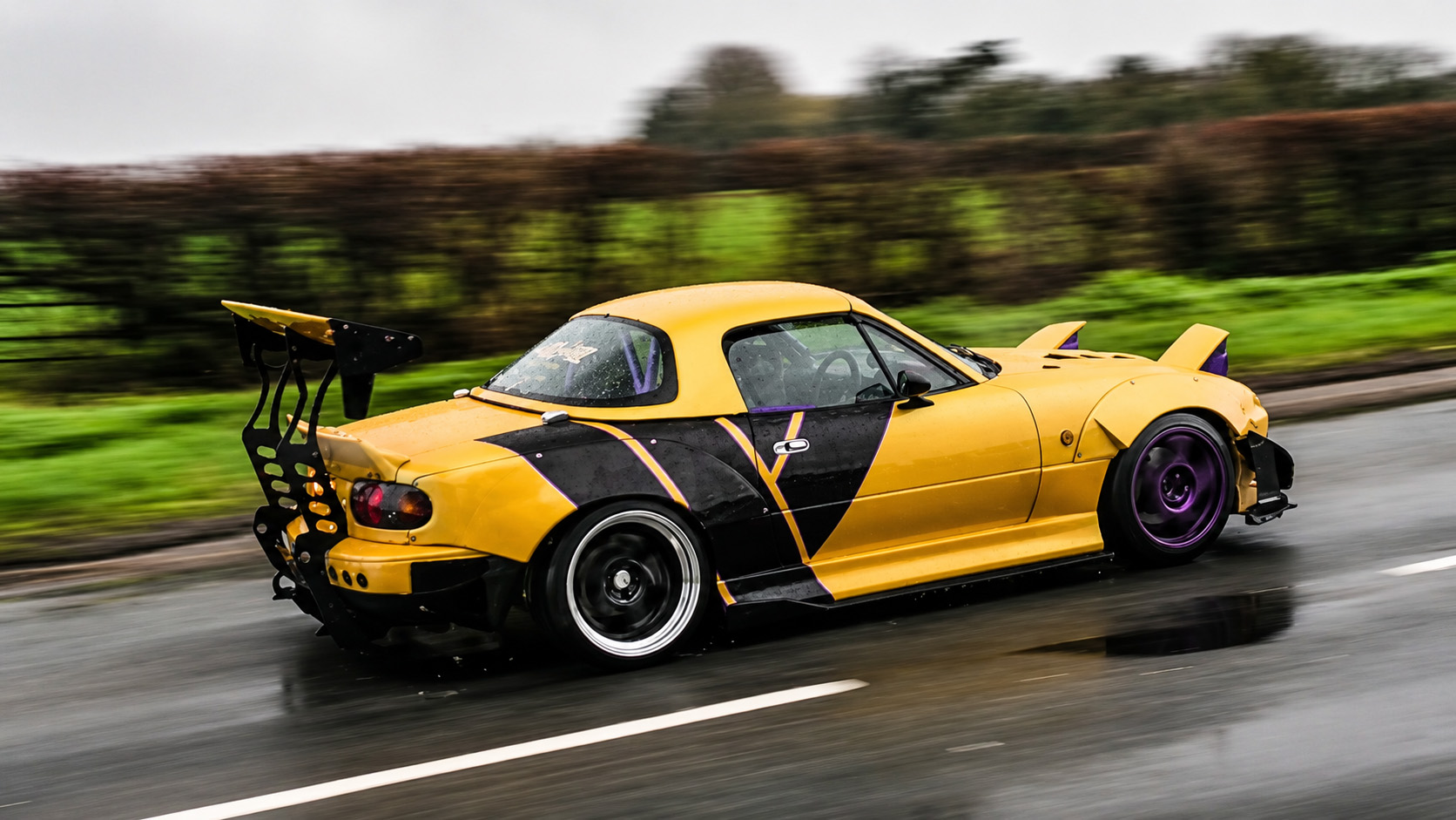 Modified cars leave Castle Combe junction with loud exhaust sounds