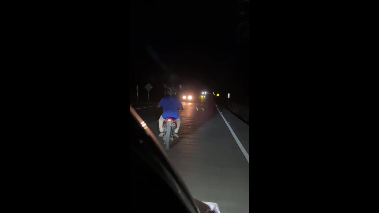 Motorcycle rides with damaged wheel on highway in Copán, Honduras