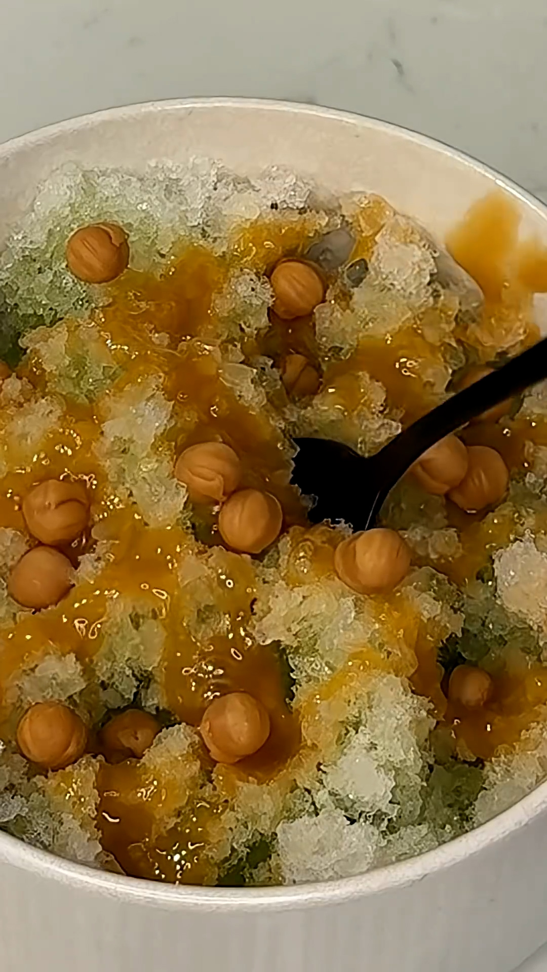 Fluffy shaved ice drizzled with caramel and apple for a cool treat