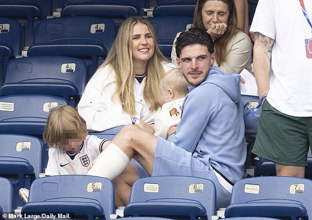 Declan Rice beams as he and partner Lauren Fryer hold baby in stands ...