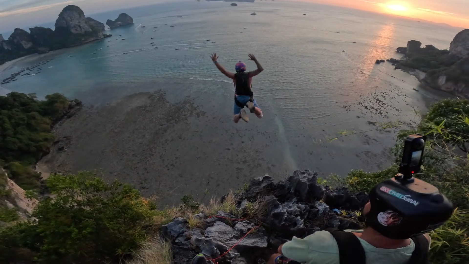 His friends watched as he jumped off a cliff onto a beach