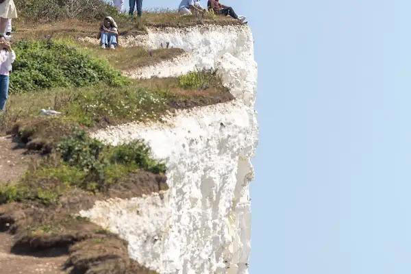 Photos show sunbaskers standing near edge of cliffs at Birling Gap