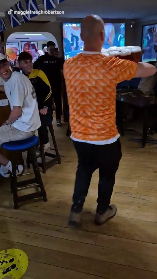 Dutch fan epically carries 26 pints of beer from the bar to his table ...