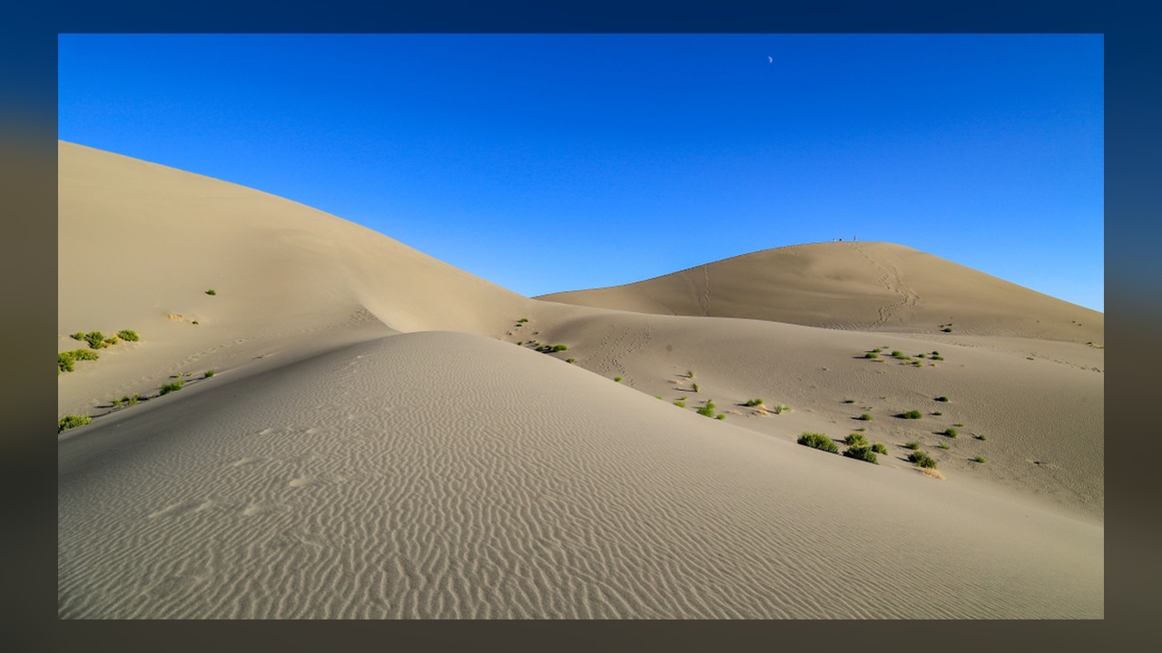 Sixty-four miles from Boise, a sand dune the size of a skyscraper glows ...